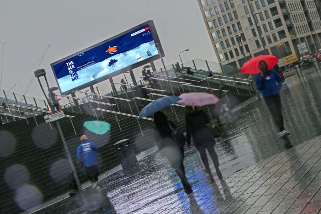 Rain triggers images in UK billboard campaign. | Billboard Insider™